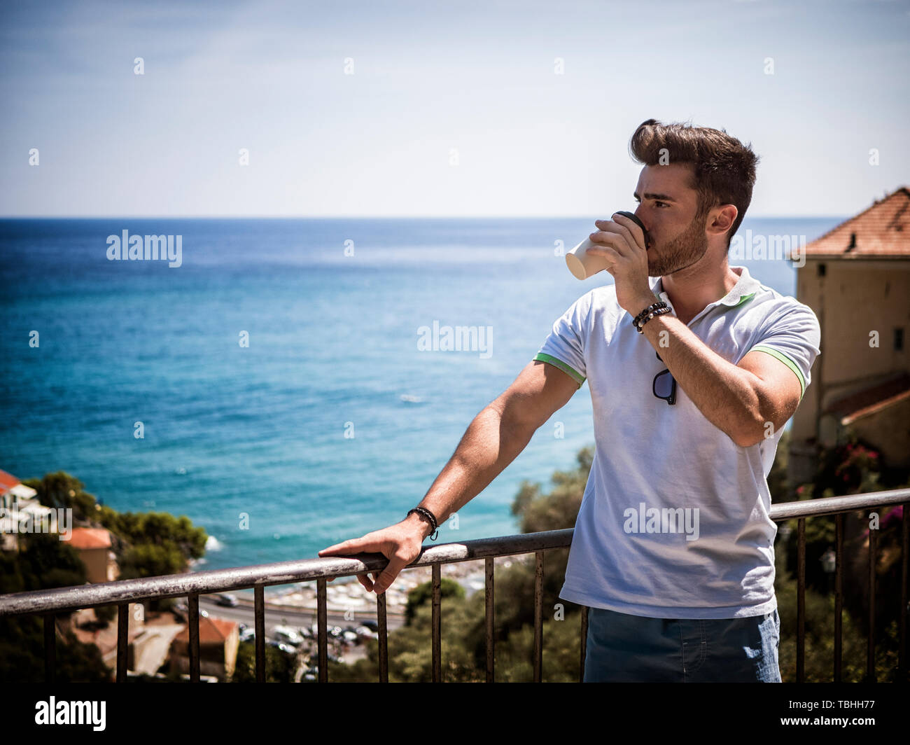 Handsome man drinking american coffee outdoor Stock Photo - Alamy