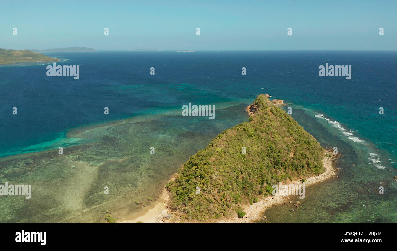 aerial view tropical island in blue lagoon, coral reef and big wave ...