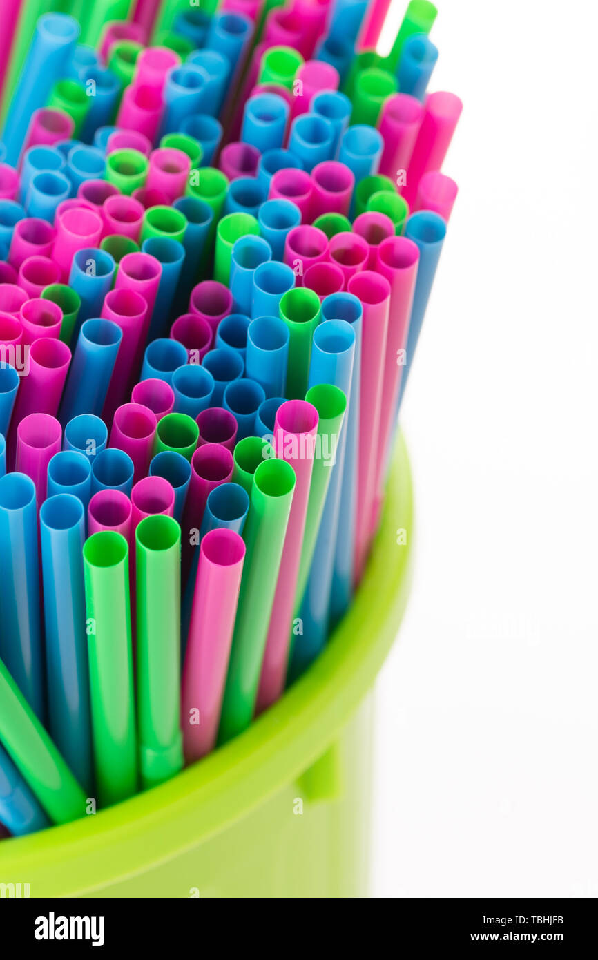 Green container of colourful drinking straws Stock Photo - Alamy