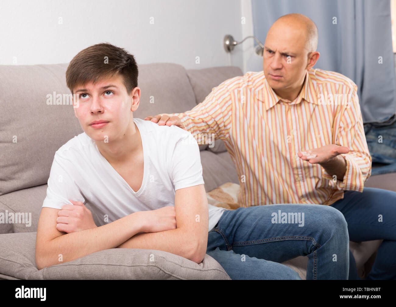 Unhappy man lecturing his teenage son at home interior Stock Photo - Alamy