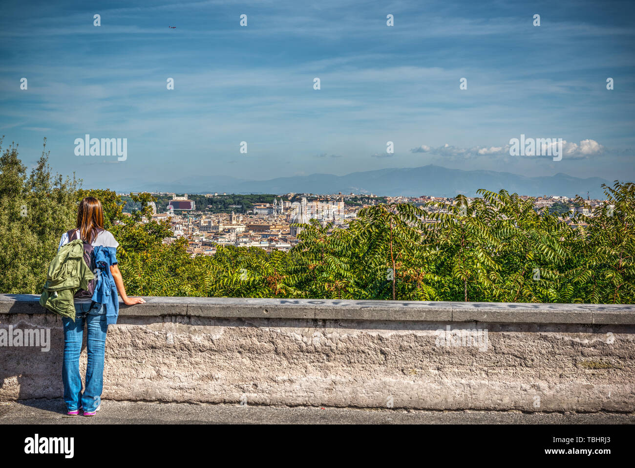 Woman in Janiculum promenade with Rome cityscape on the background ...