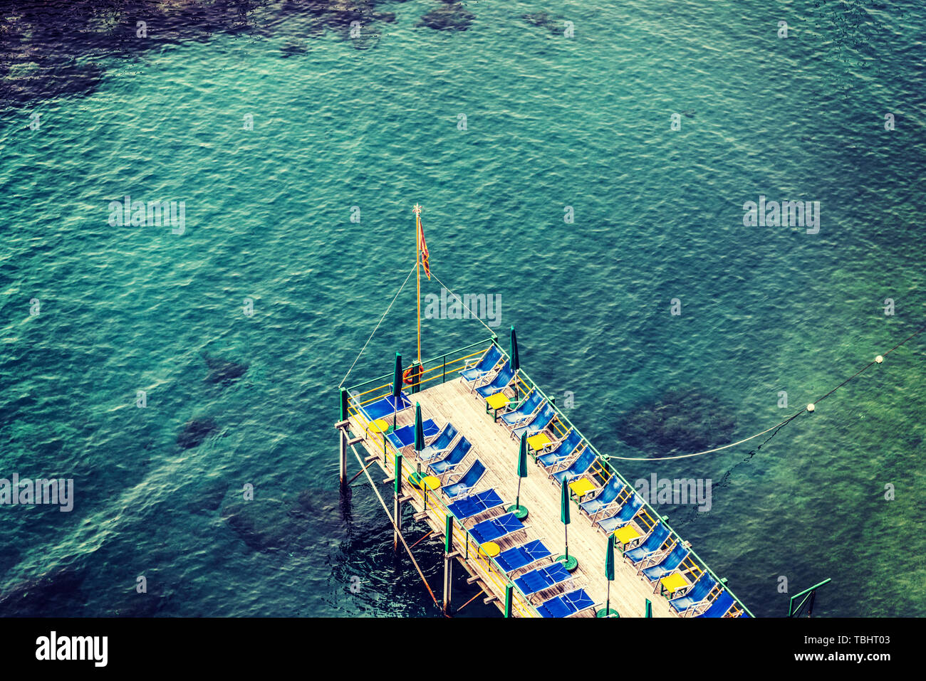 Beach chairs and parasols on a pier in Sorrento coast. Campania, Italy ...