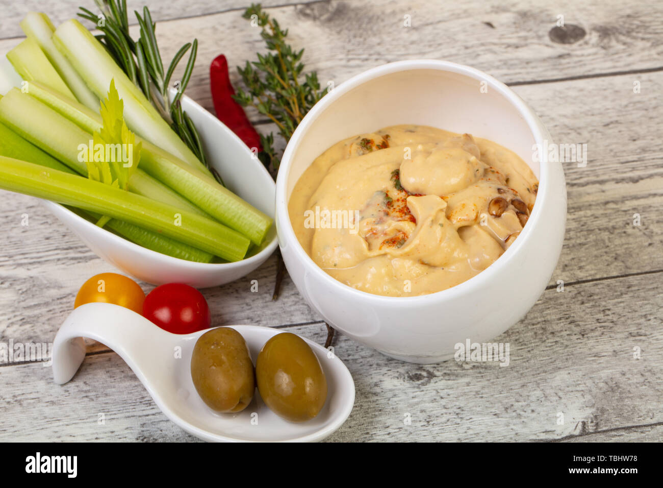 Vegan cuisine - Humus with celery sticks Stock Photo - Alamy
