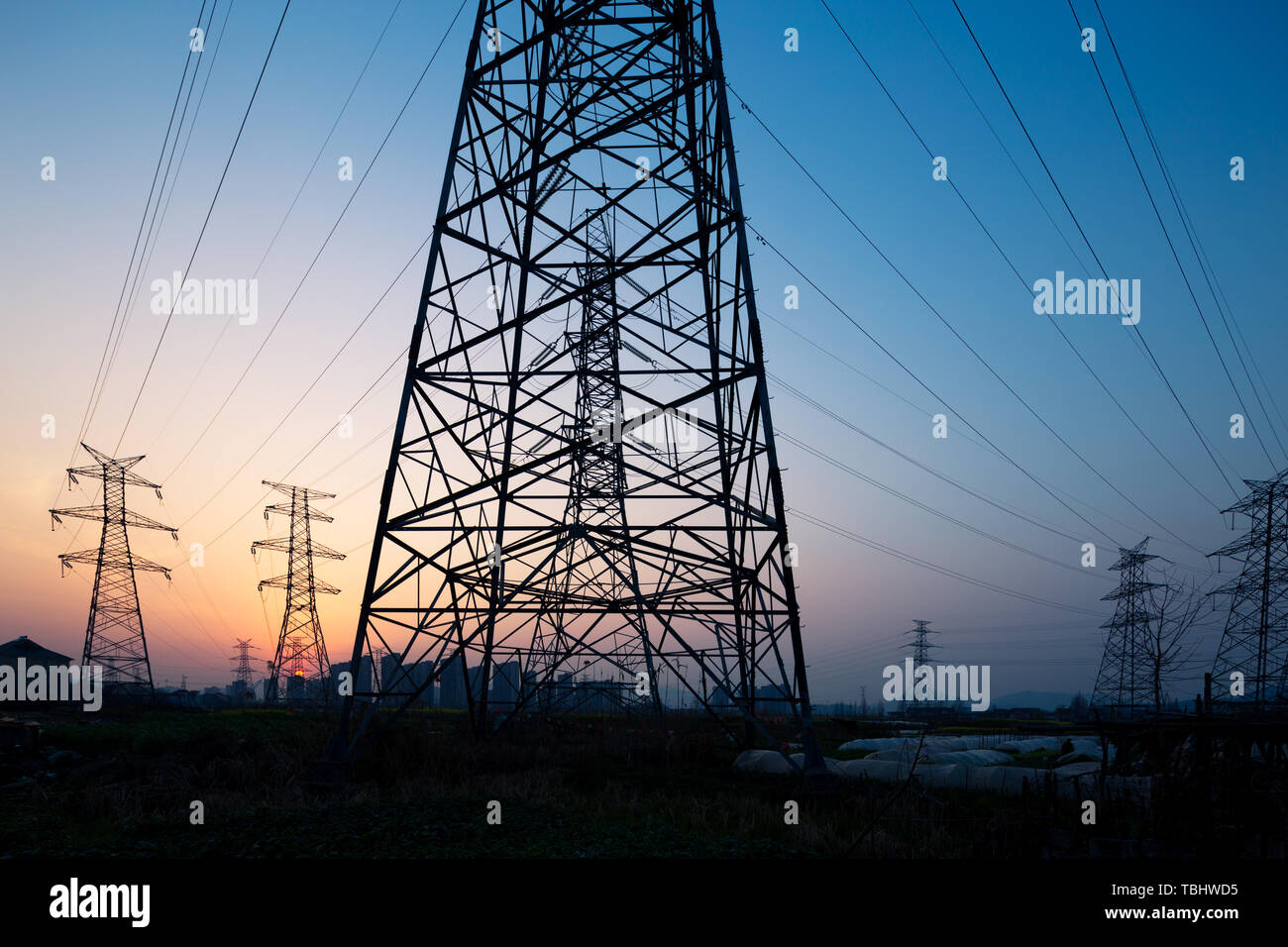 Pylons in blue sky at sunrise Stock Photo - Alamy