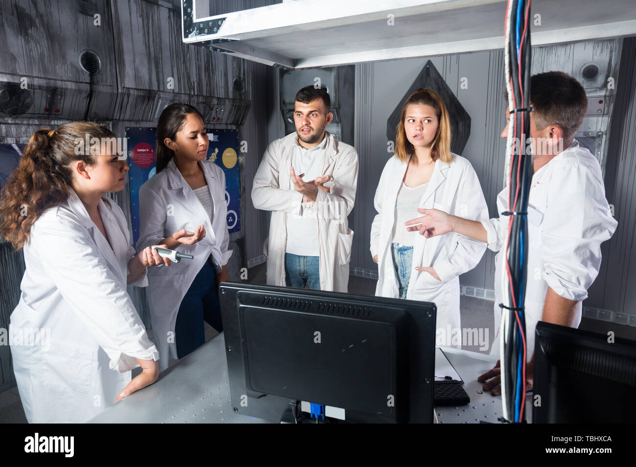 Adults are solving quests to get out of escape room stylized like ...