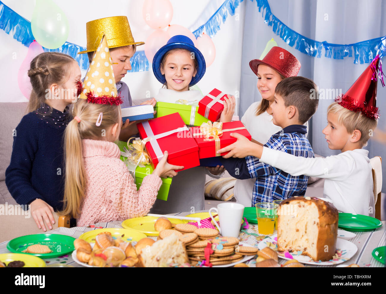 happy children giving presents to little girl during party Stock Photo ...