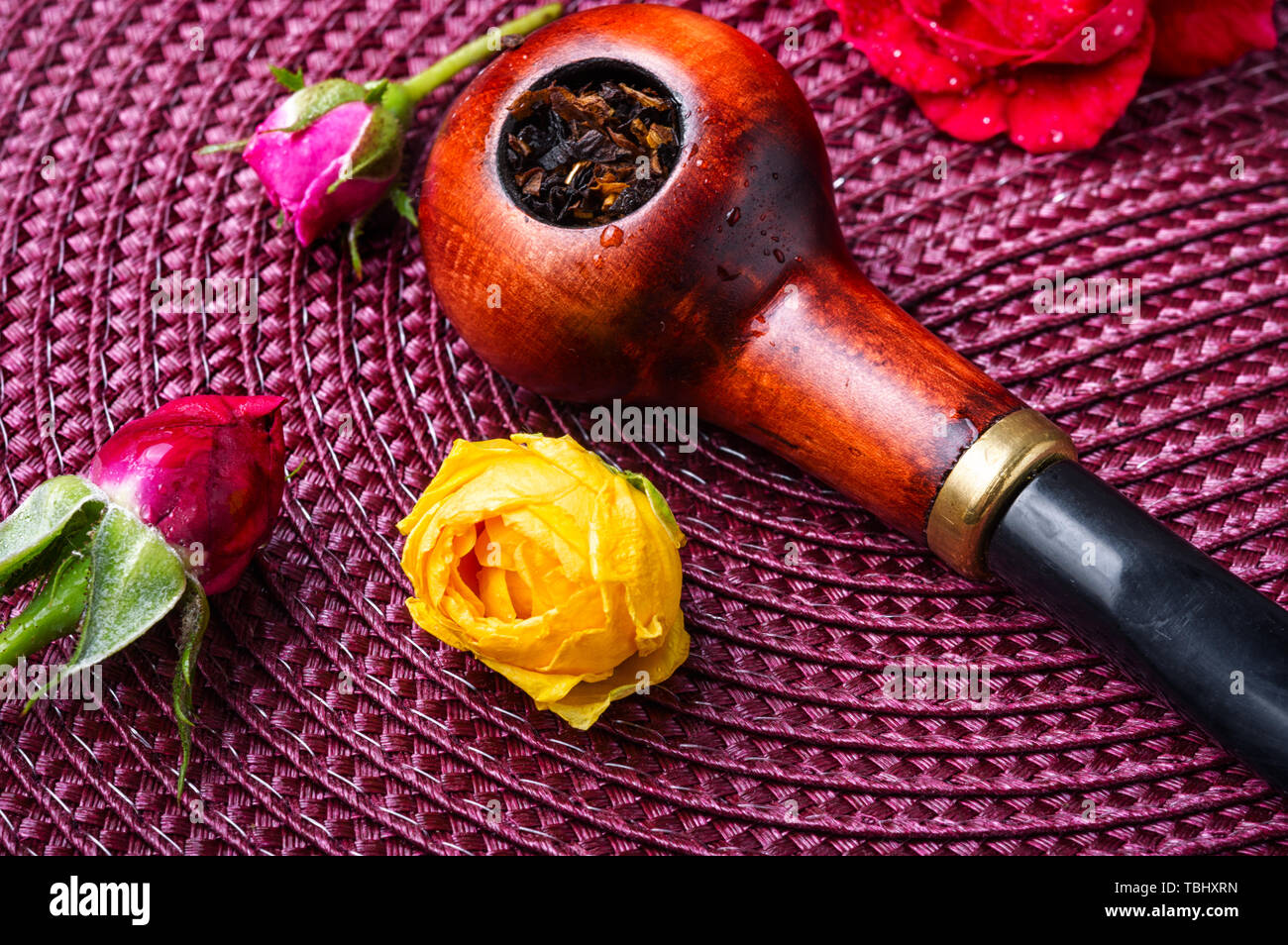 Tobacco pipe and smoking tobacco with rose flavor Stock Photo - Alamy