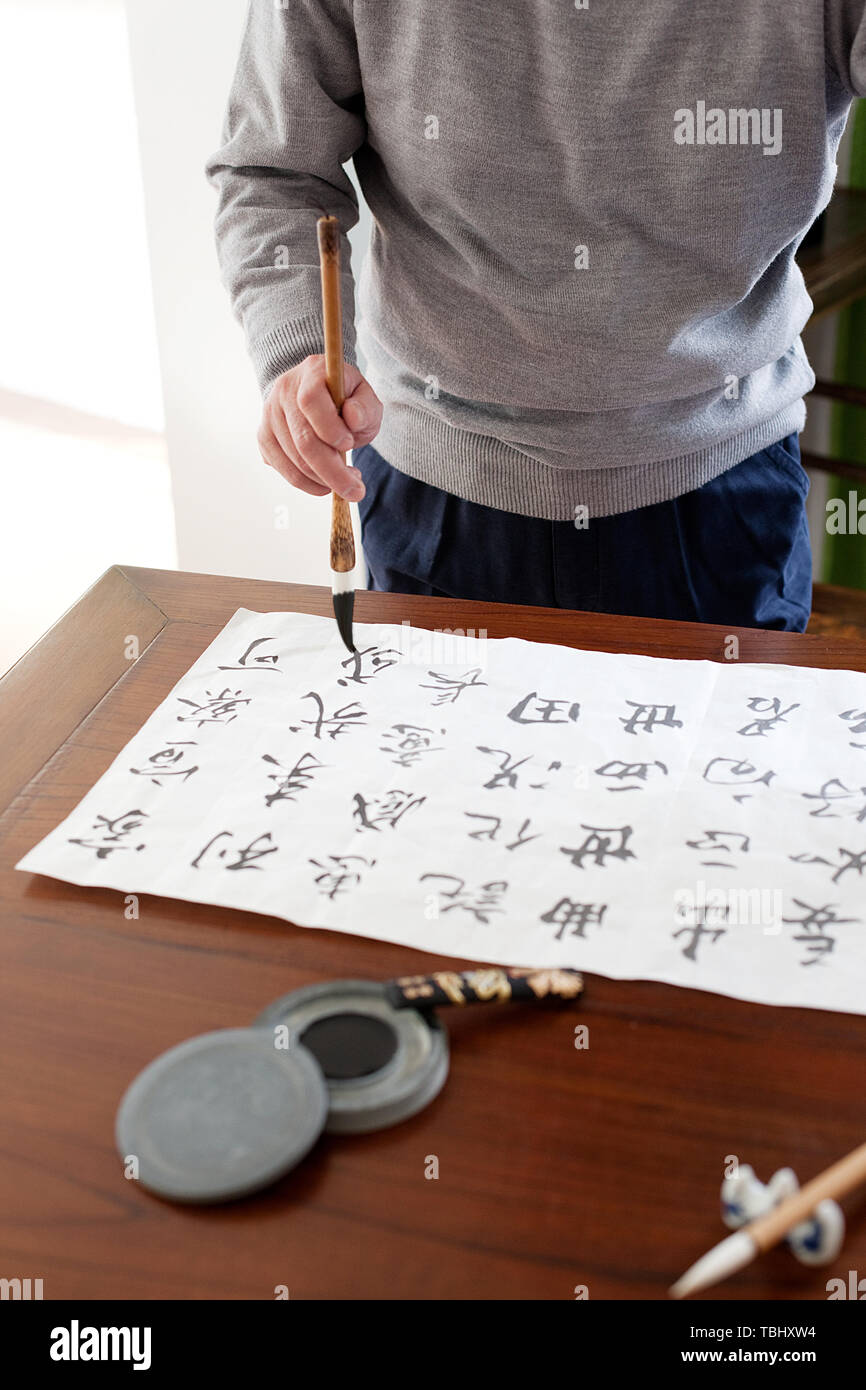 An elderly man practicing calligraphy Stock Photo - Alamy