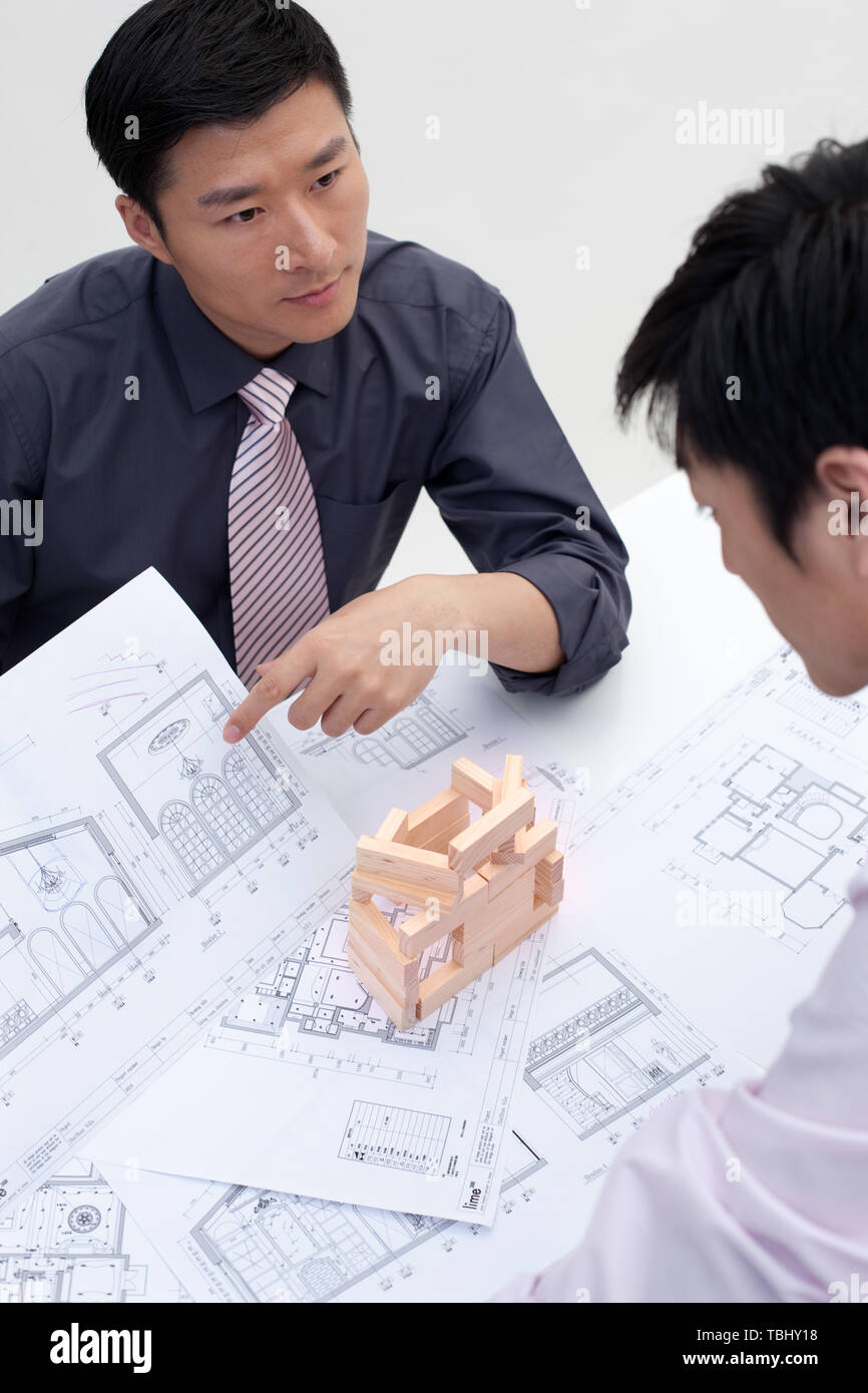 Business people analyzing drawings Stock Photo - Alamy