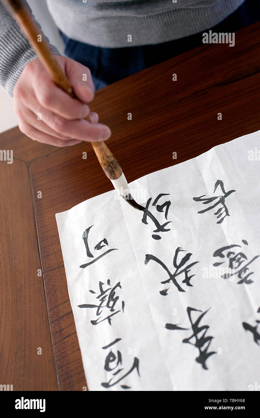 An elderly man practicing calligraphy Stock Photo - Alamy