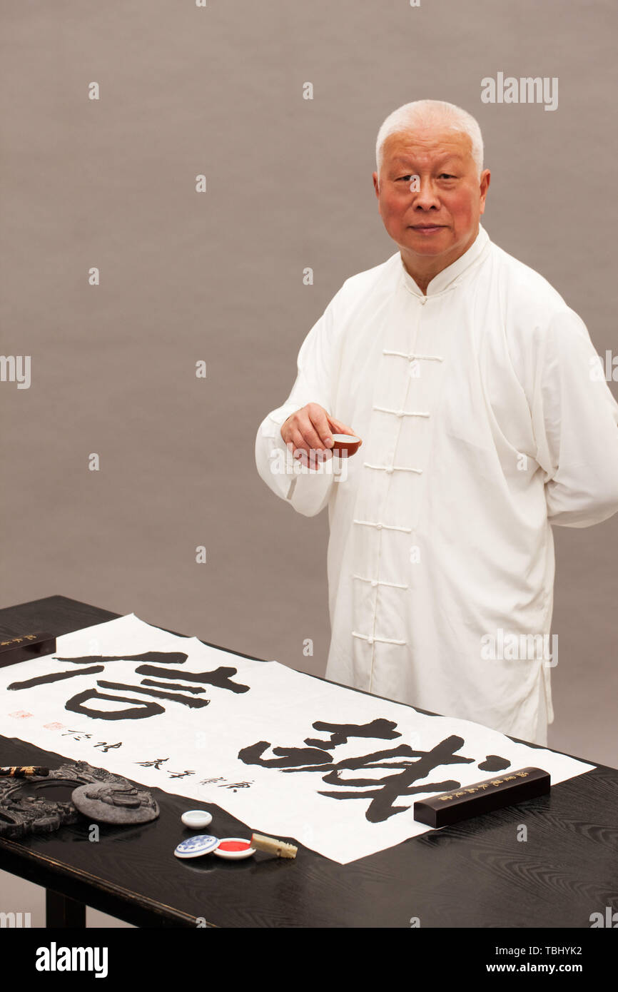 An old man practicing calligraphy Stock Photo - Alamy