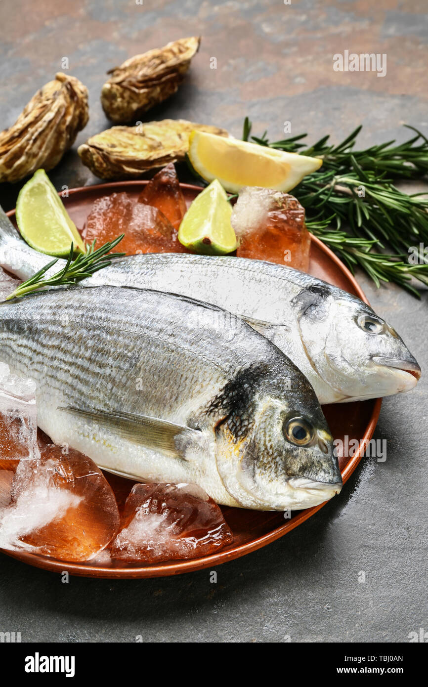 Fresh fish on grey table Stock Photo - Alamy