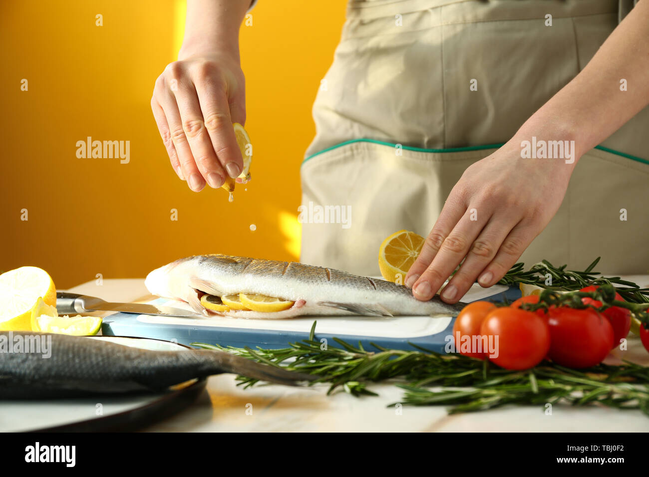 Woman preparing tasty fresh fish Stock Photo - Alamy