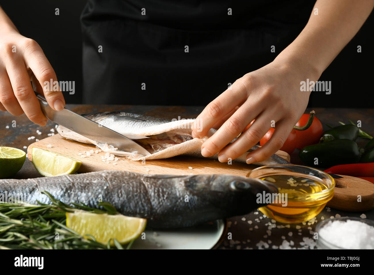 Woman preparing tasty fresh fish Stock Photo - Alamy