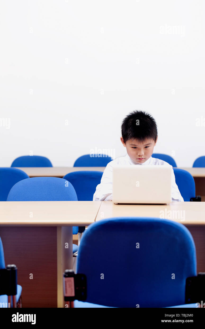 Three primary school students are in class in the classroom Stock Photo ...