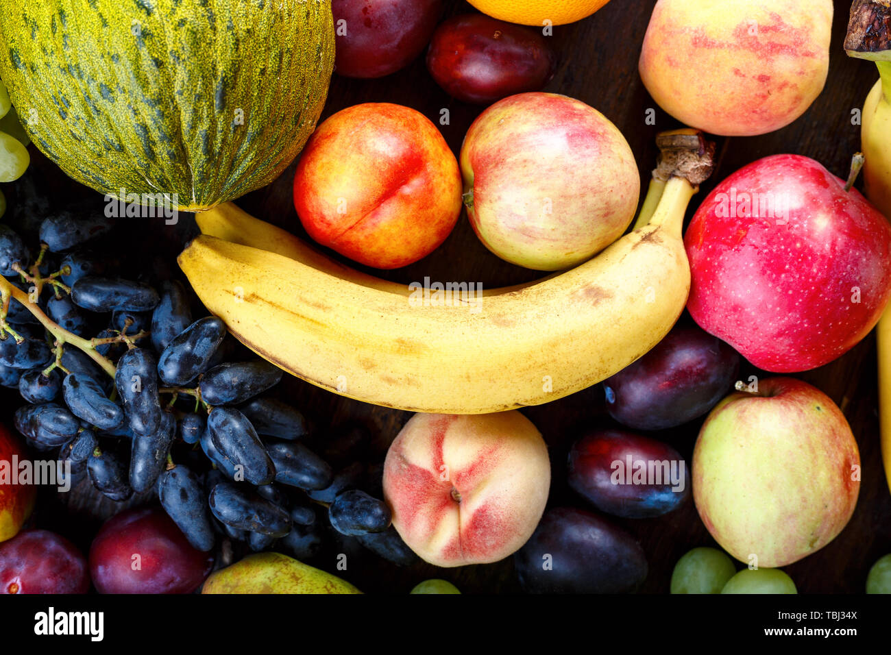 different ripe exotic fruits set. fruits are scattered as a background ...