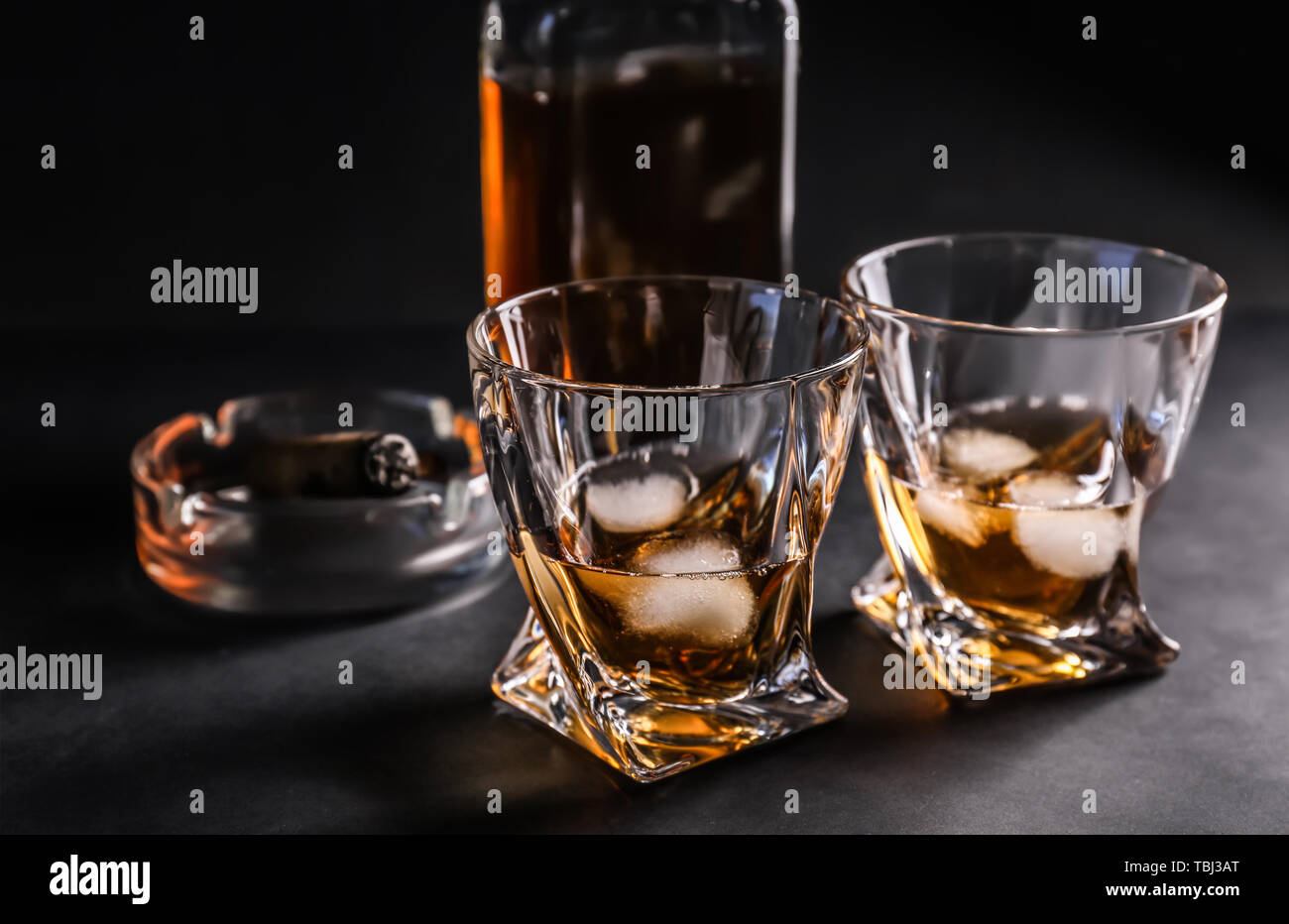 Glasses of cold whiskey on dark background Stock Photo - Alamy