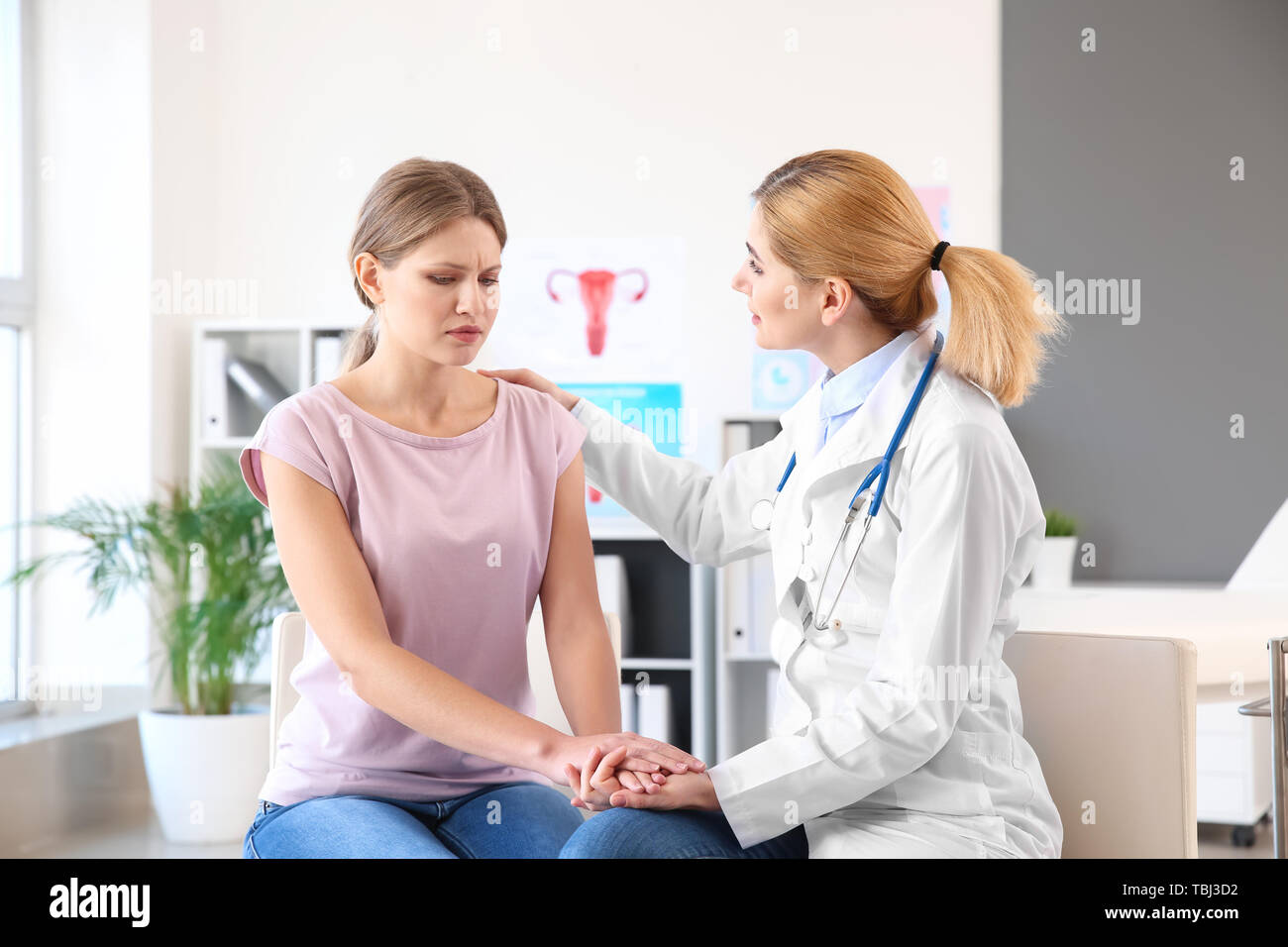 Gynecologist calming young patient in office Stock Photo - Alamy