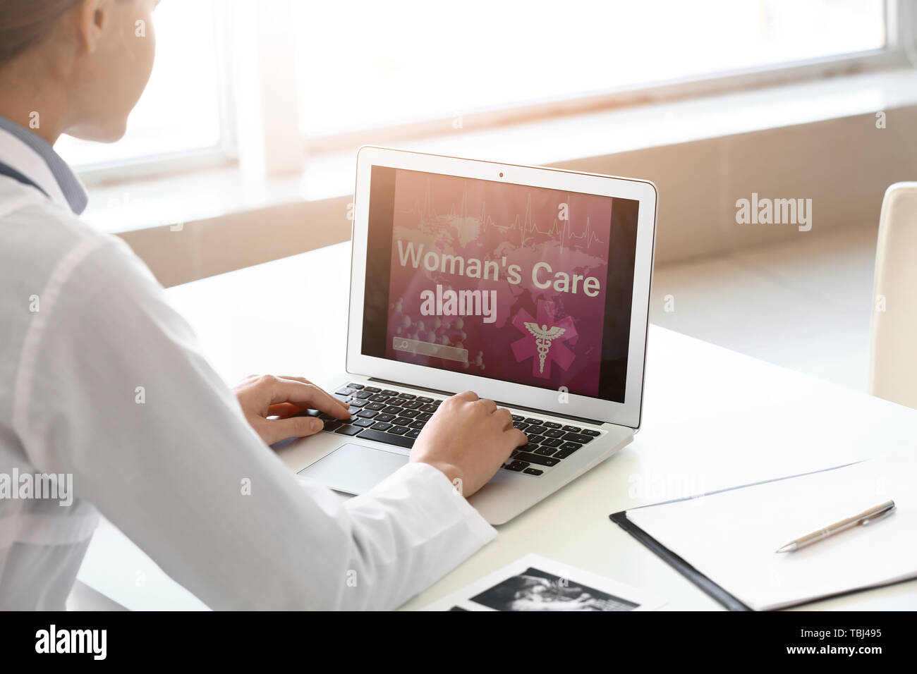 Young gynecologist with laptop working in her office Stock Photo - Alamy