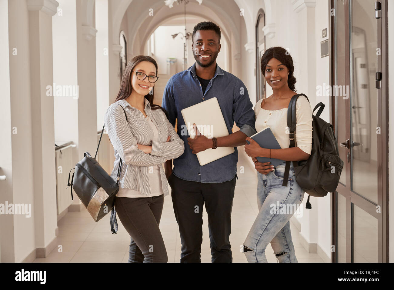 Happy classmates standing studying together hi-res stock photography ...