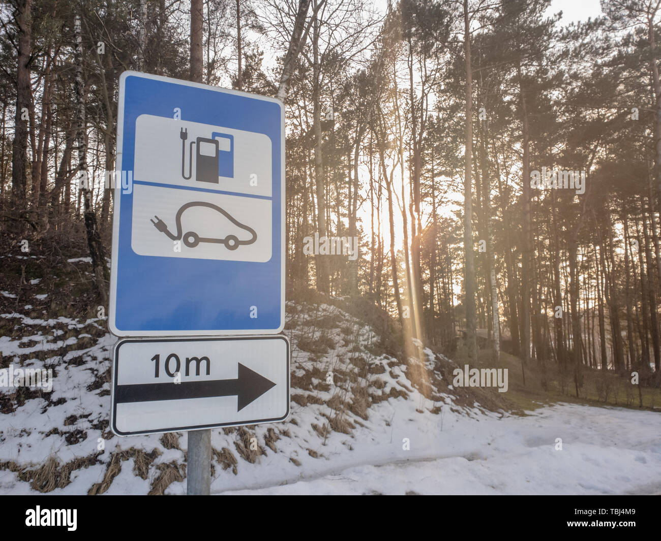 Road sign to EV Electric car charging station Stock Photo - Alamy