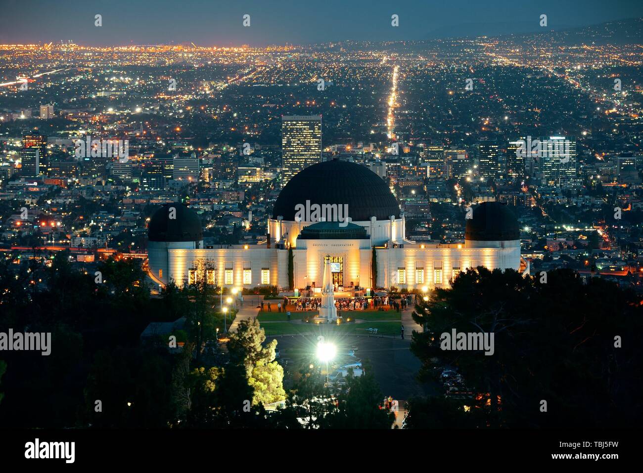 Los Angeles at night with urban buildings and Griffith Observatory ...