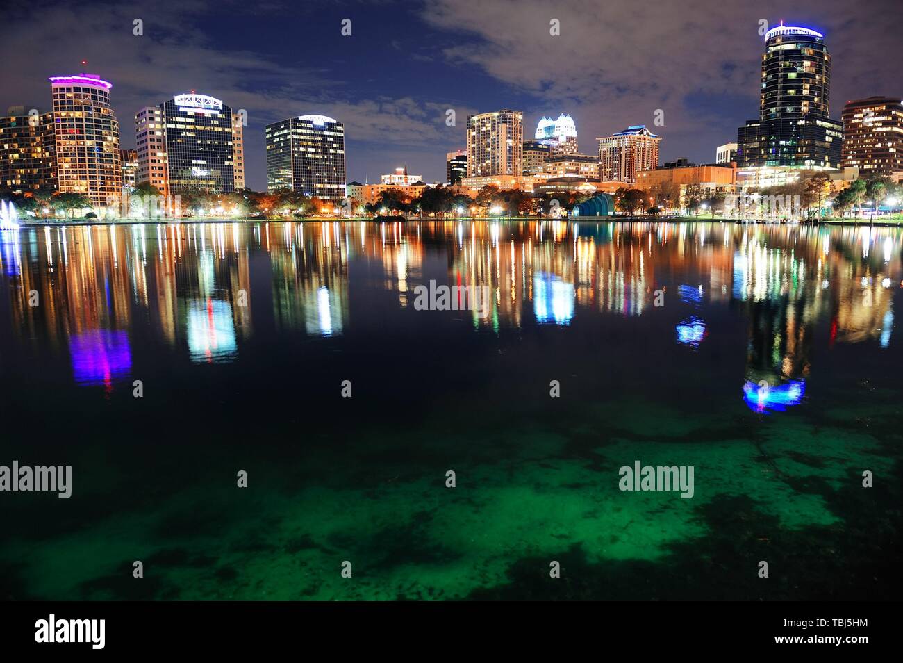 Orlando downtown skyline over Lake Eola at dusk with urban skyscrapers ...