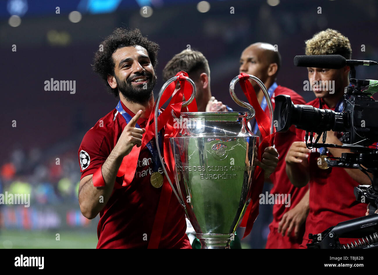 Liverpool's Mohamed Salah celebrates with the trophy after the UEFA ...