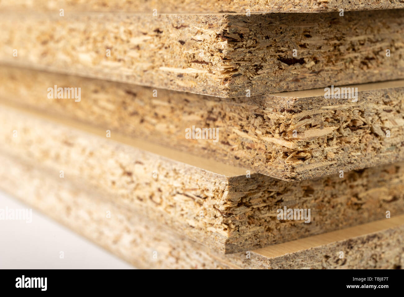 Particleboard with veneer is cut into small pieces. Materials for ...