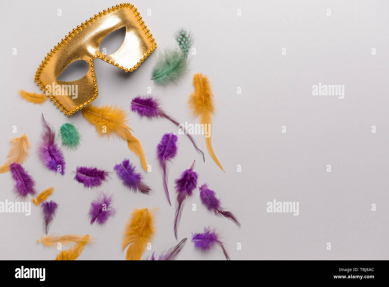 Festive mask with feathers on light background Stock Photo - Alamy