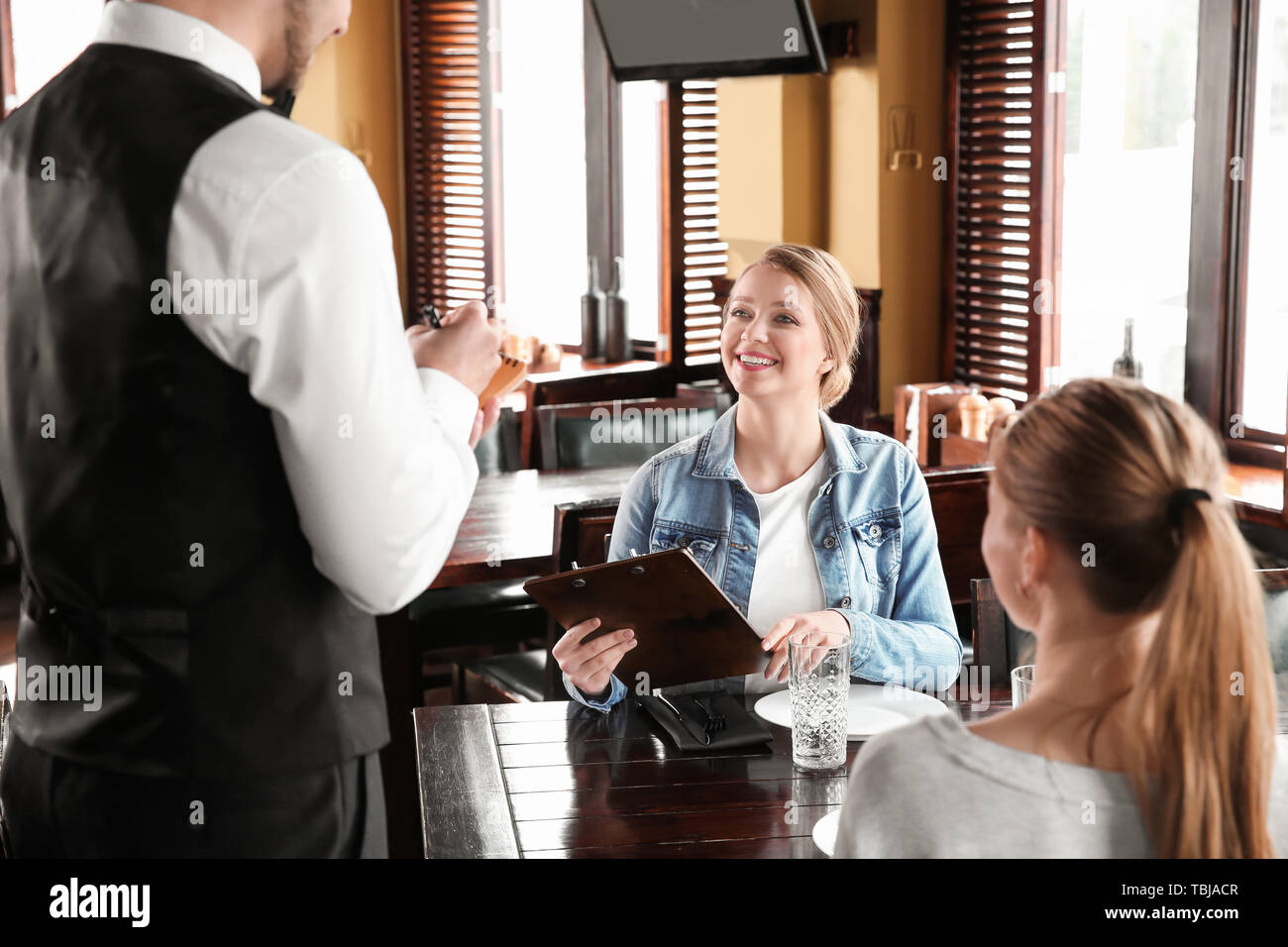 Waiter taking order in restaurant Stock Photo - Alamy