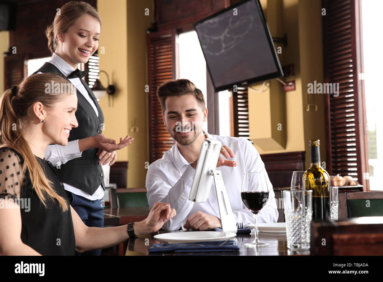 Waiter taking order in restaurant Stock Photo - Alamy