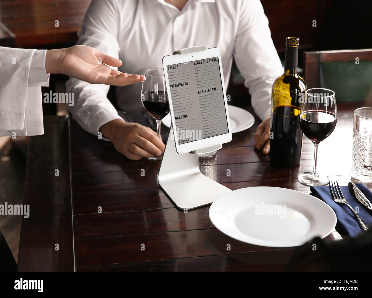 Waiter taking order in restaurant Stock Photo - Alamy