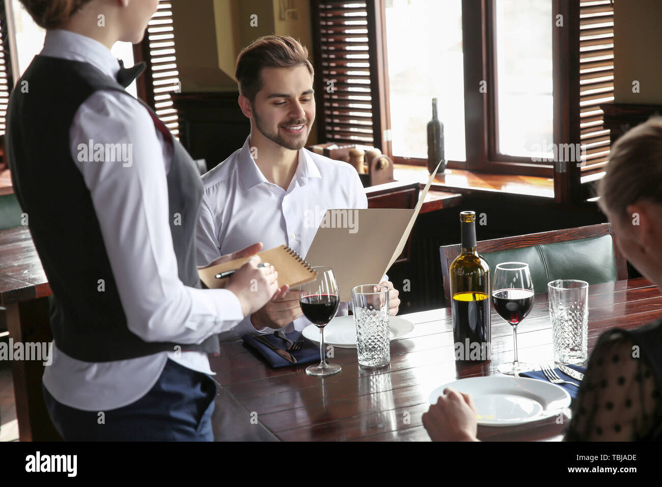 Waiter taking order in restaurant Stock Photo - Alamy