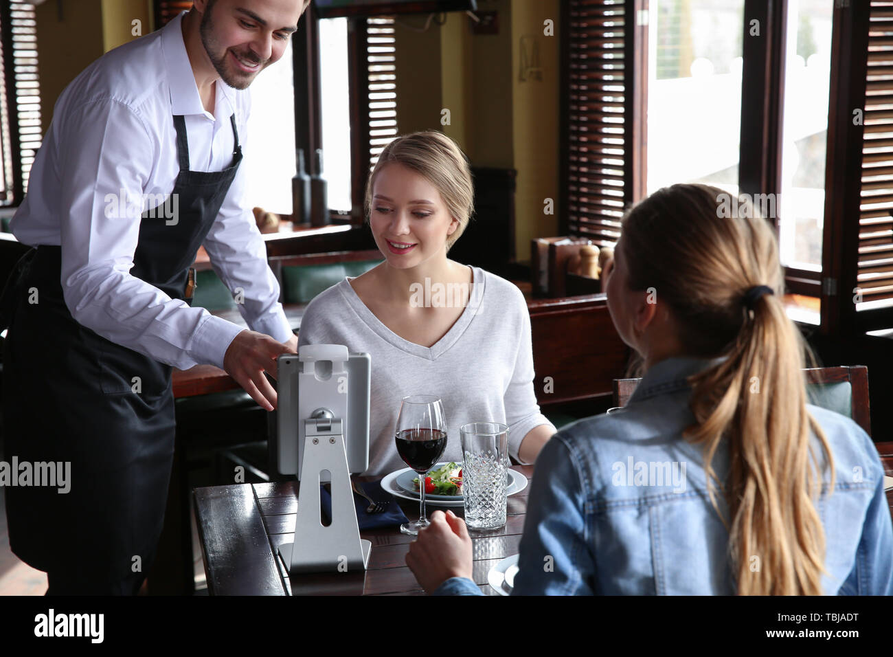 Waiter taking order in restaurant Stock Photo - Alamy