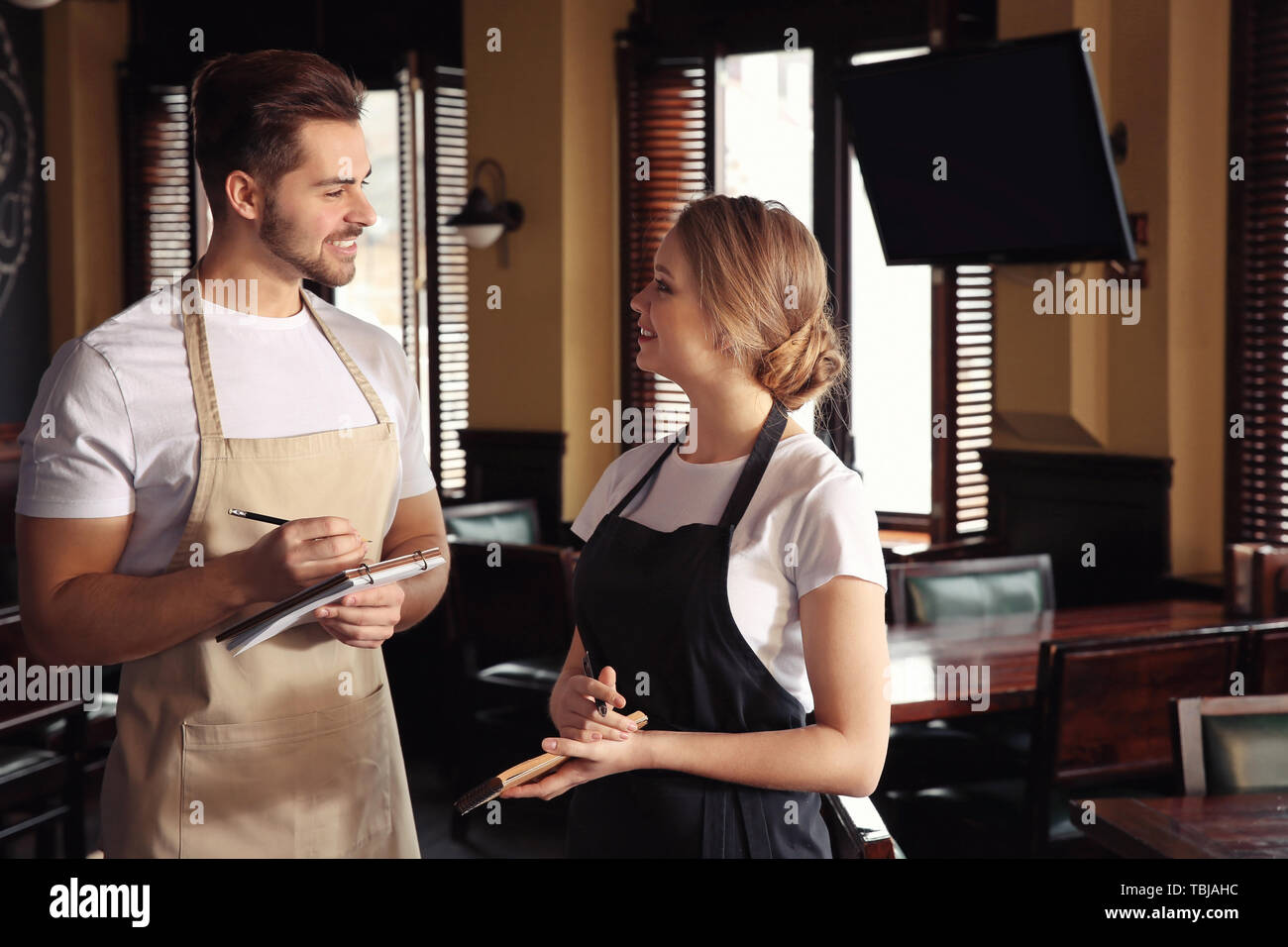 Young waiters in restaurant Stock Photo - Alamy