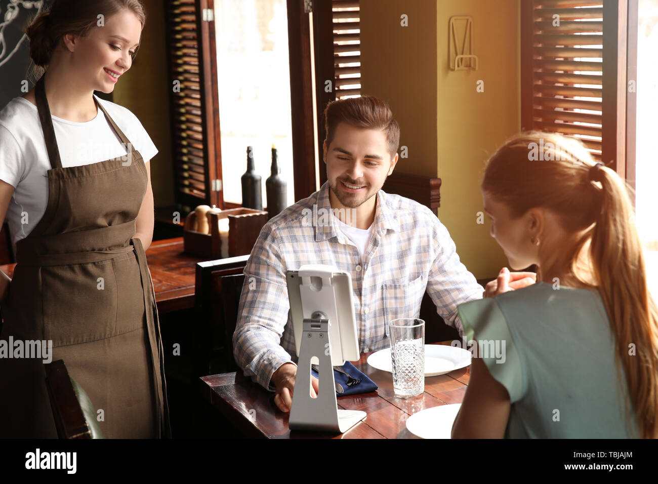 Waiter taking order in restaurant Stock Photo - Alamy
