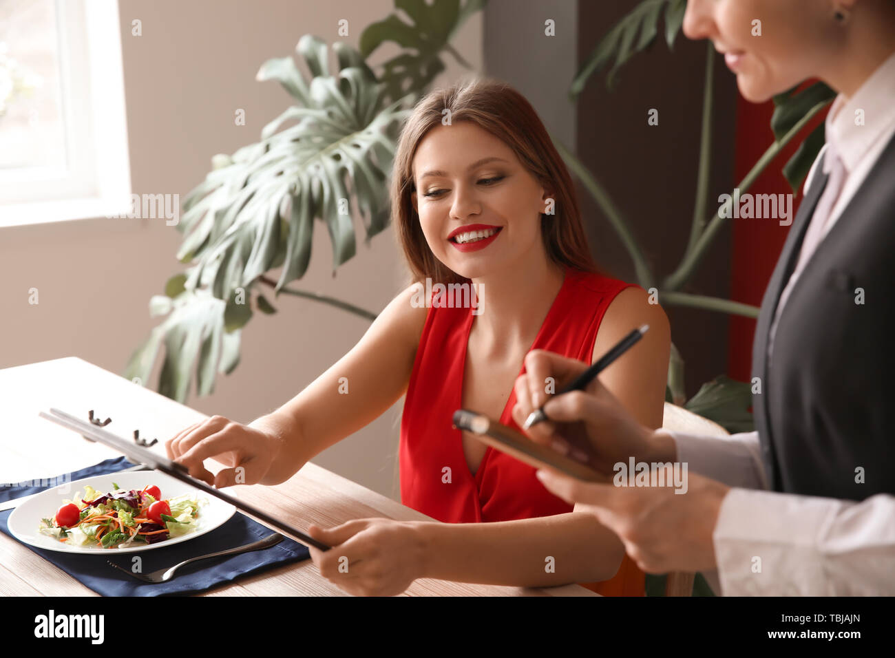Waiter taking order in restaurant Stock Photo - Alamy