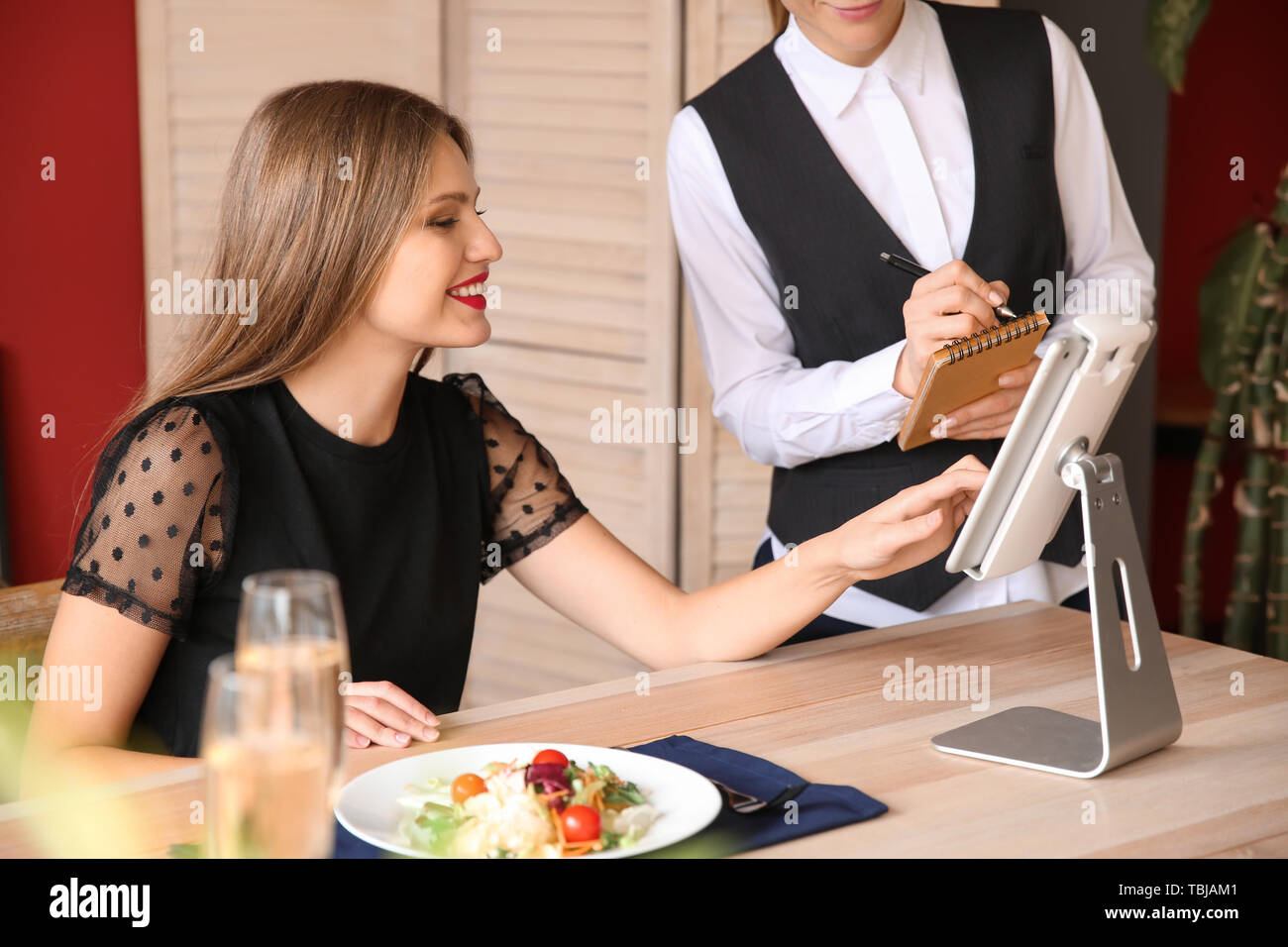 Waiter taking order in restaurant Stock Photo - Alamy