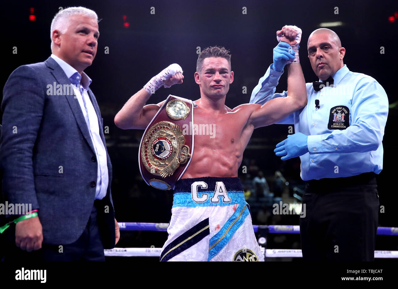 Chris Algieri (centre) celebrates winning the WBA International Super ...