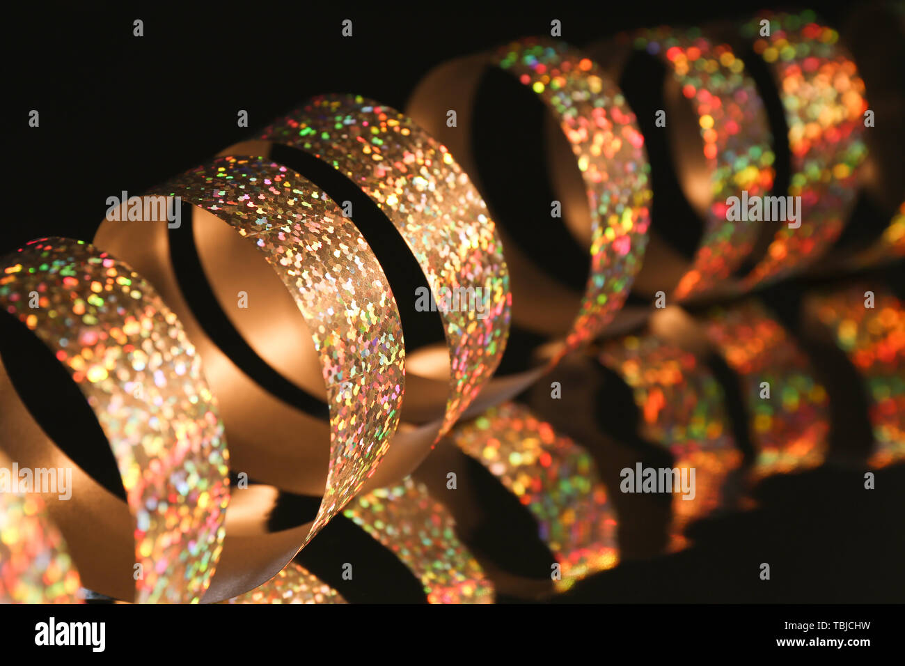 Shiny streamer on dark background, closeup Stock Photo - Alamy