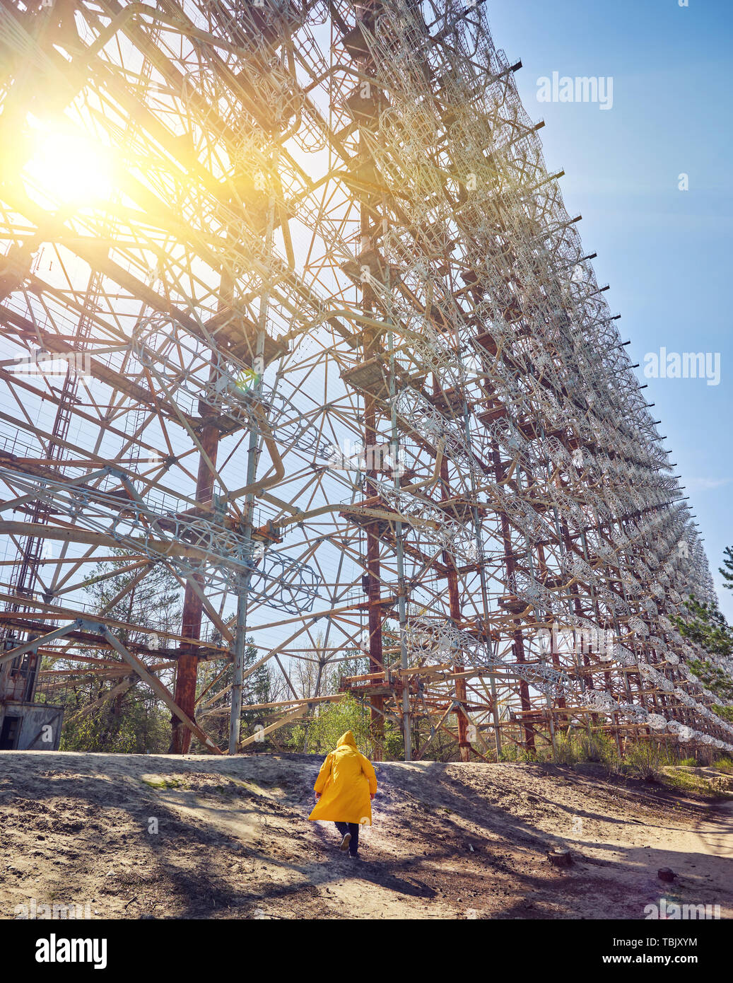 young man in yellow protective suit standing near military secret ...