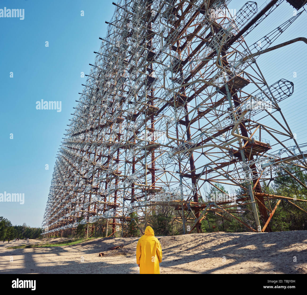 young man in yellow protective suit standing near military secret ...