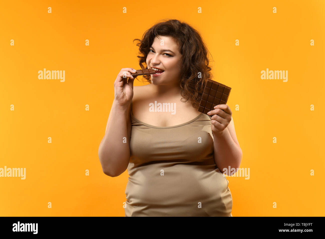 Overweight woman eating chocolate hi-res stock photography and images ...