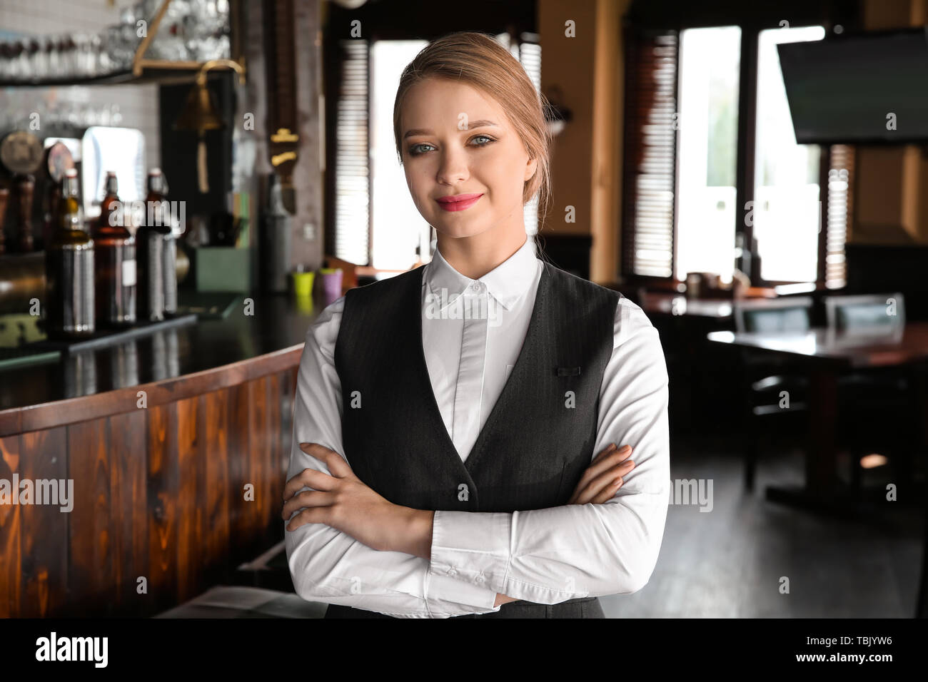 Young female waiter in restaurant Stock Photo - Alamy