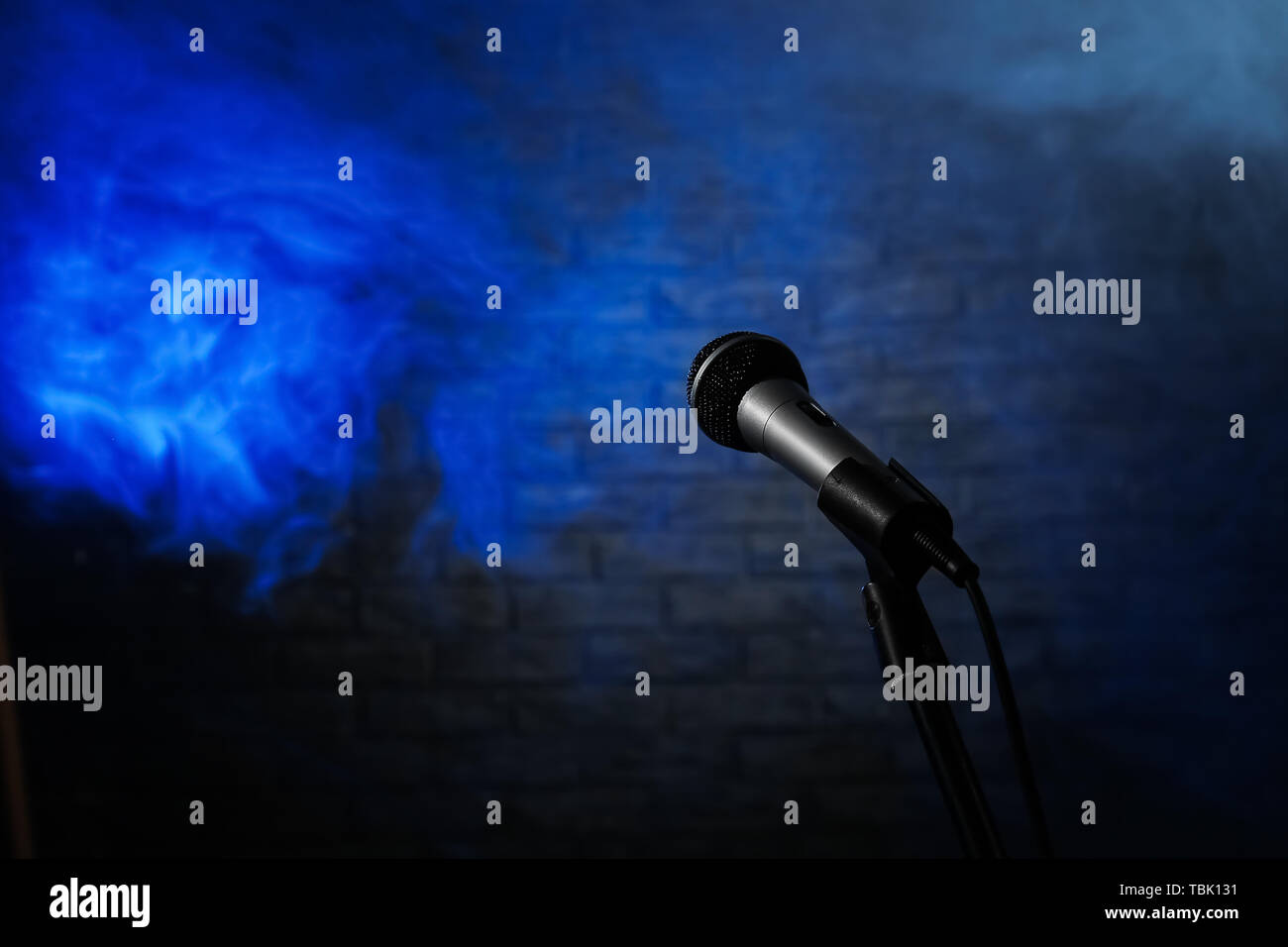 Modern microphone in smoke on stage Stock Photo - Alamy