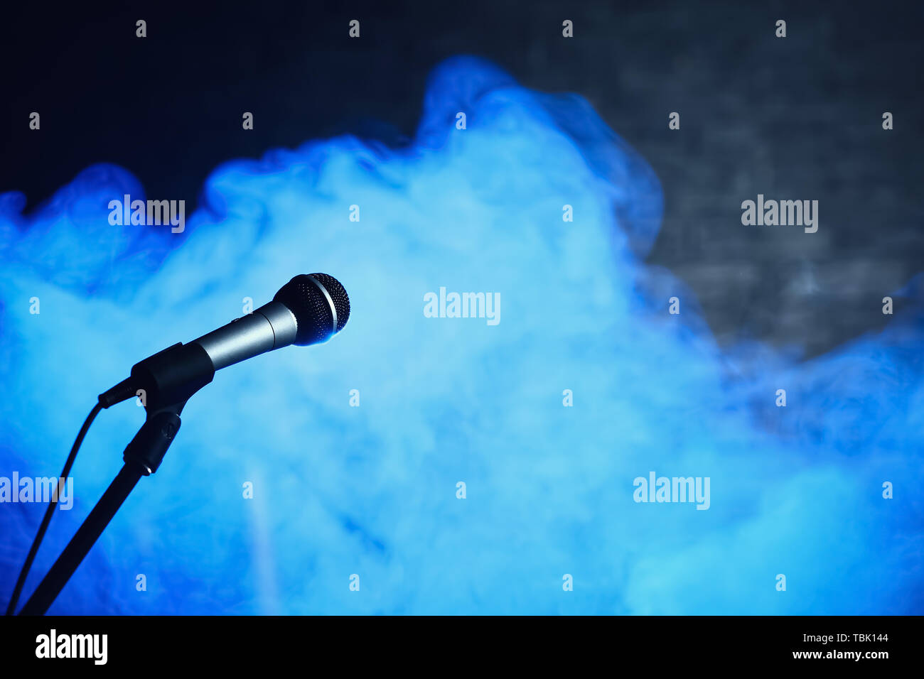 Modern microphone in smoke on stage Stock Photo - Alamy