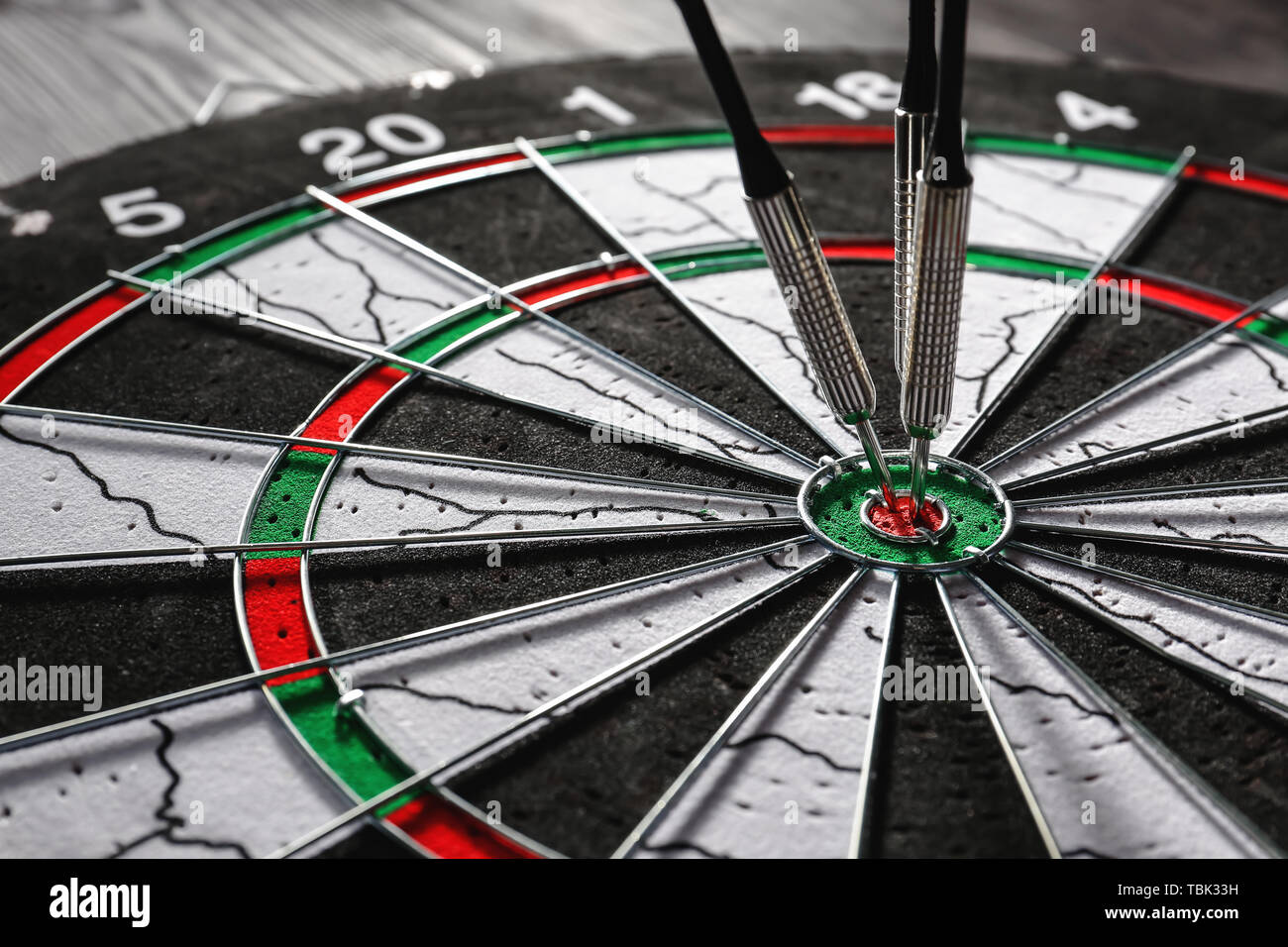 Dartboard with hit bullseye, closeup Stock Photo - Alamy