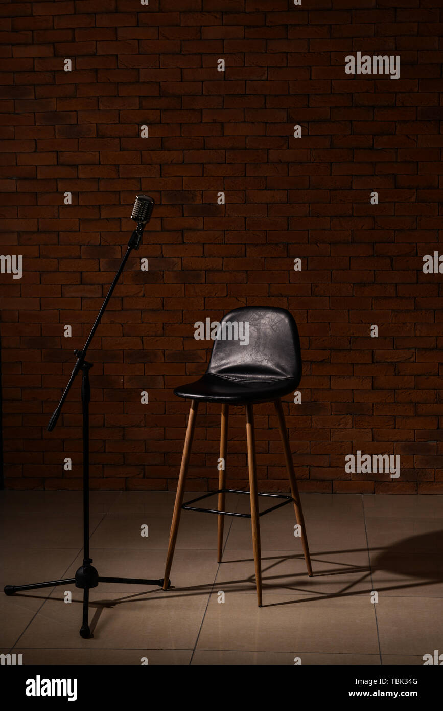 Microphone with chair in studio Stock Photo - Alamy