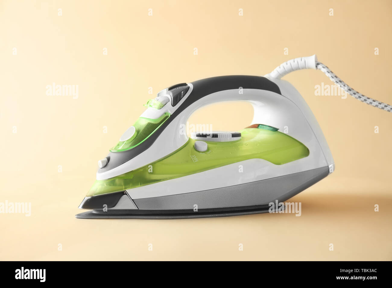 Modern iron on color background Stock Photo - Alamy